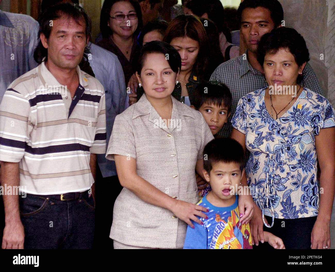 Philippine President Gloria Macapagal Arroyo, center, walks with freed ...
