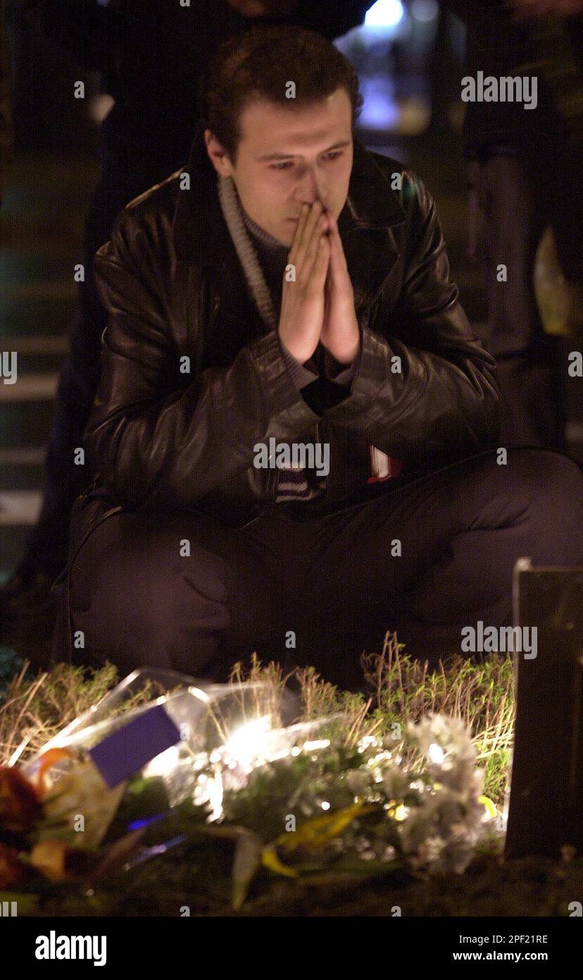 A man prays near to flower tributes placed for Macedonia's President ...
