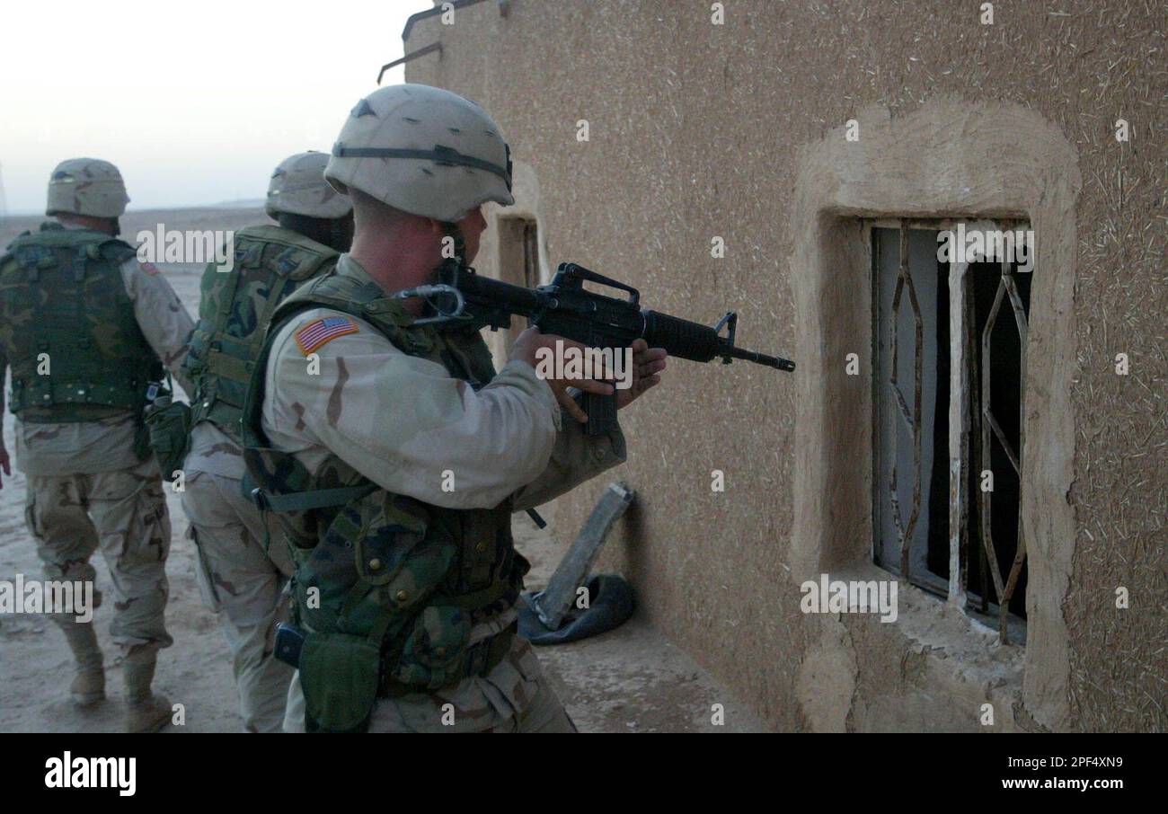 A US soldier from the 720 Military Police battalion checks through a ...
