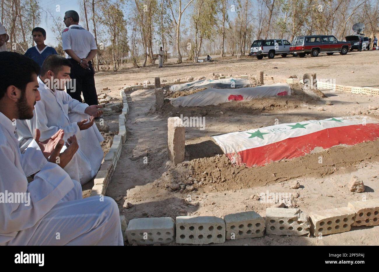 Friends and family members grieve as they recite pieces of the holy ...