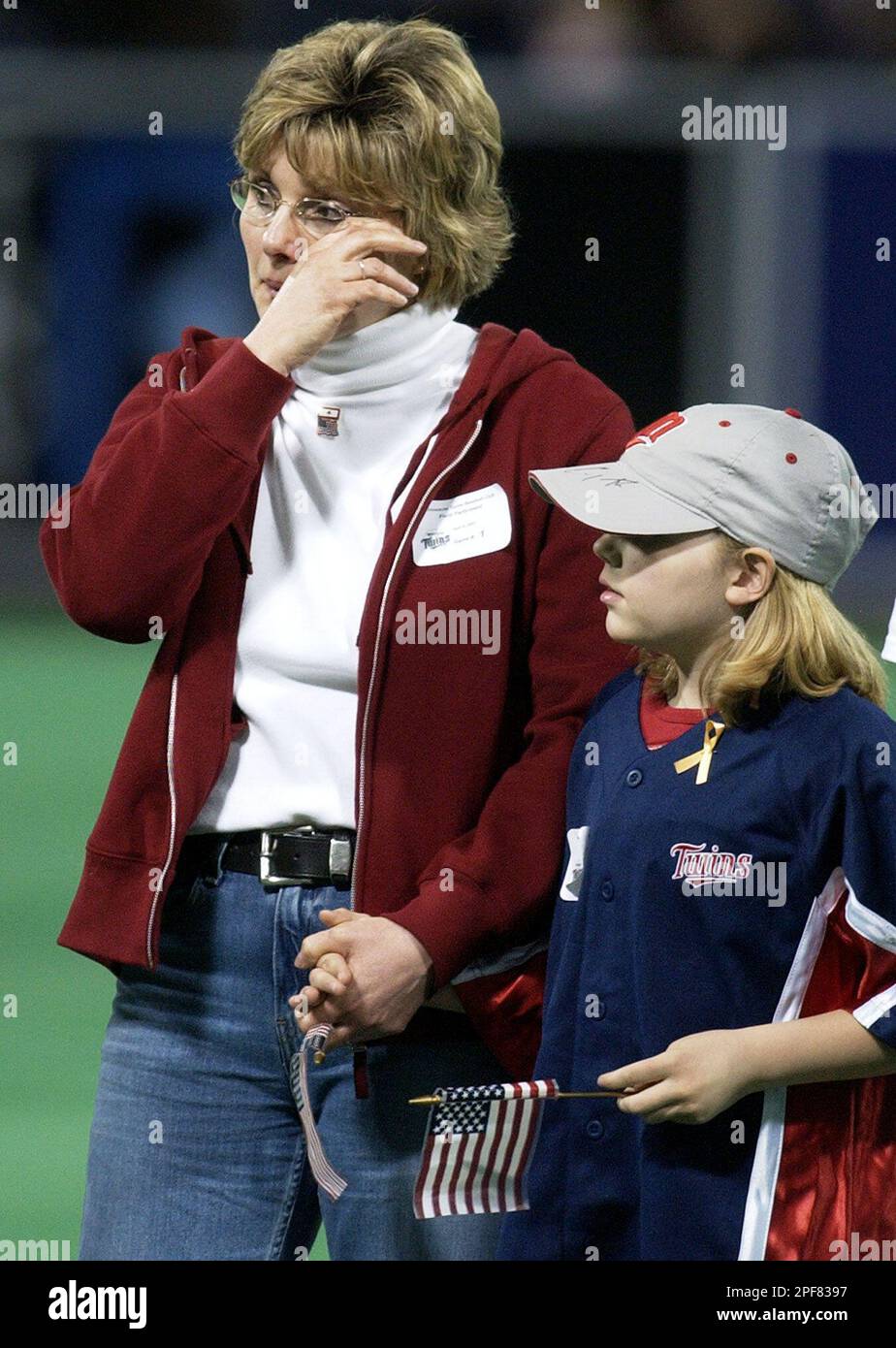 Kathy Dvorak, left, wipes a tear as she leaves the field with her ...