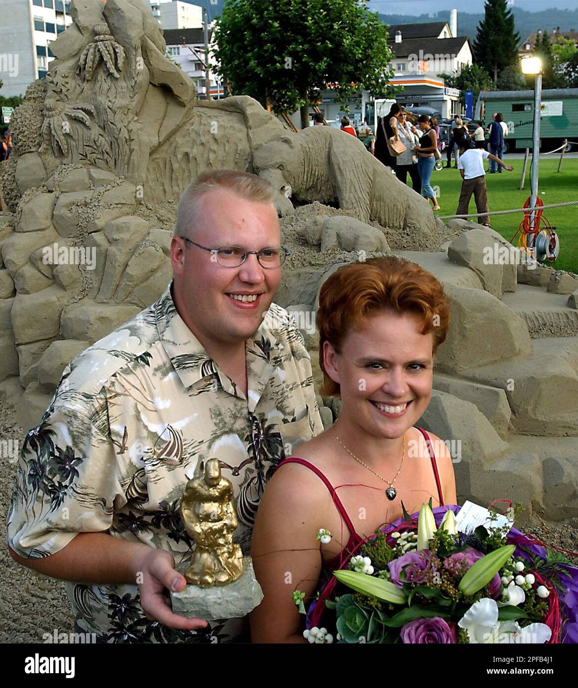 Frosti, left, and Tarja Kimmo, of Finland, hold a small trophy and a ...
