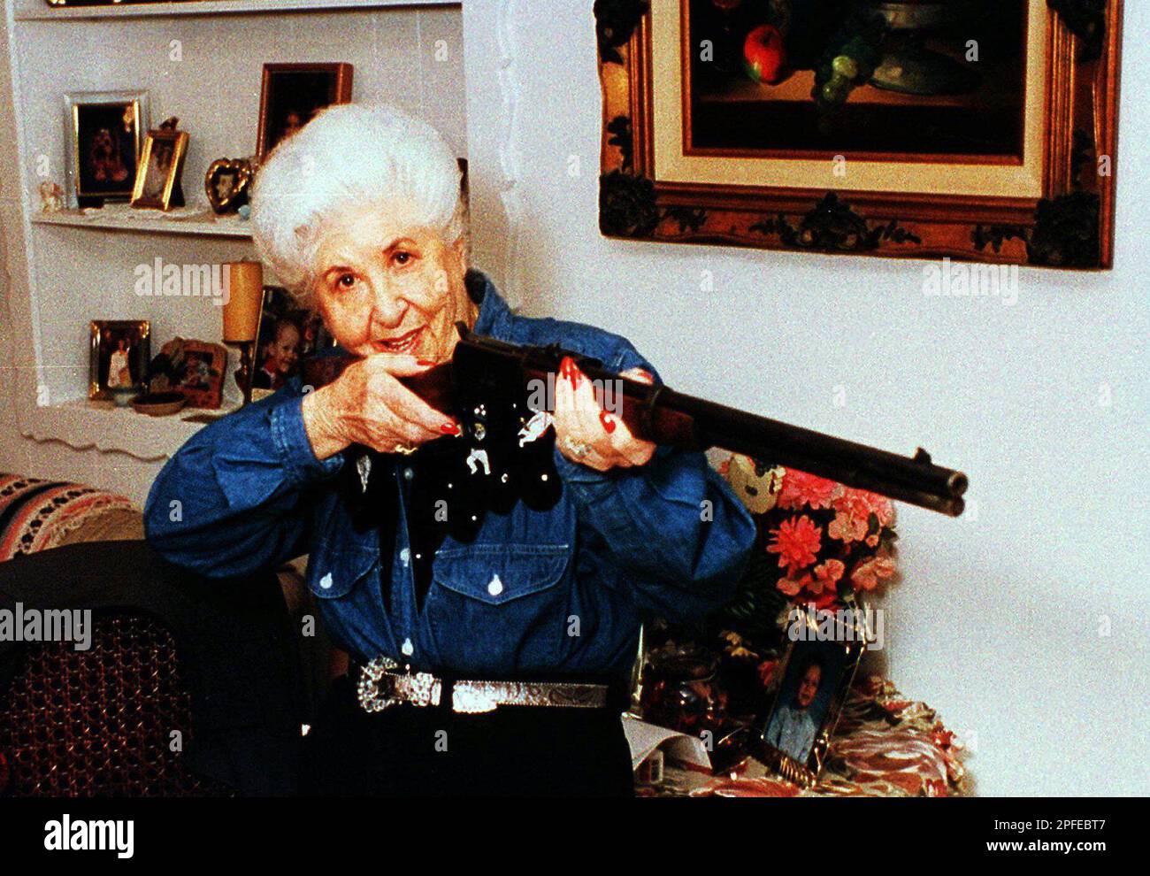 Marie Barrow, sister of famous Dallas outlaw Clyde Barrow, holds one of ...