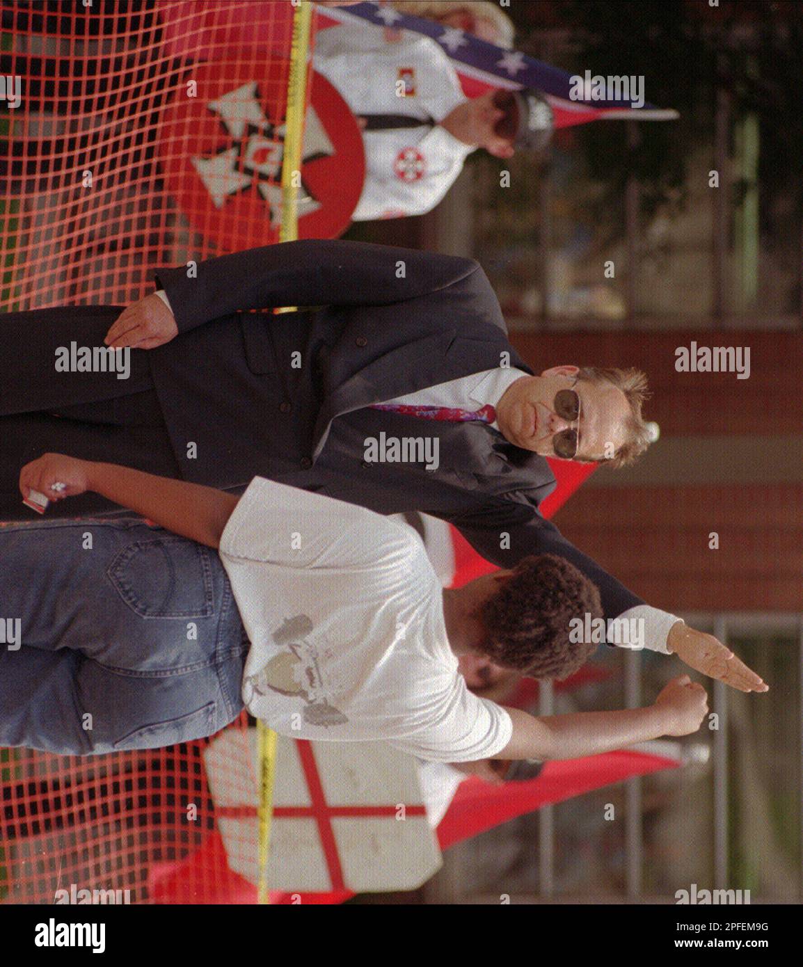 Tiffaeny Lanigan gives a clenched fist salute to Ku Klux Klan members ...