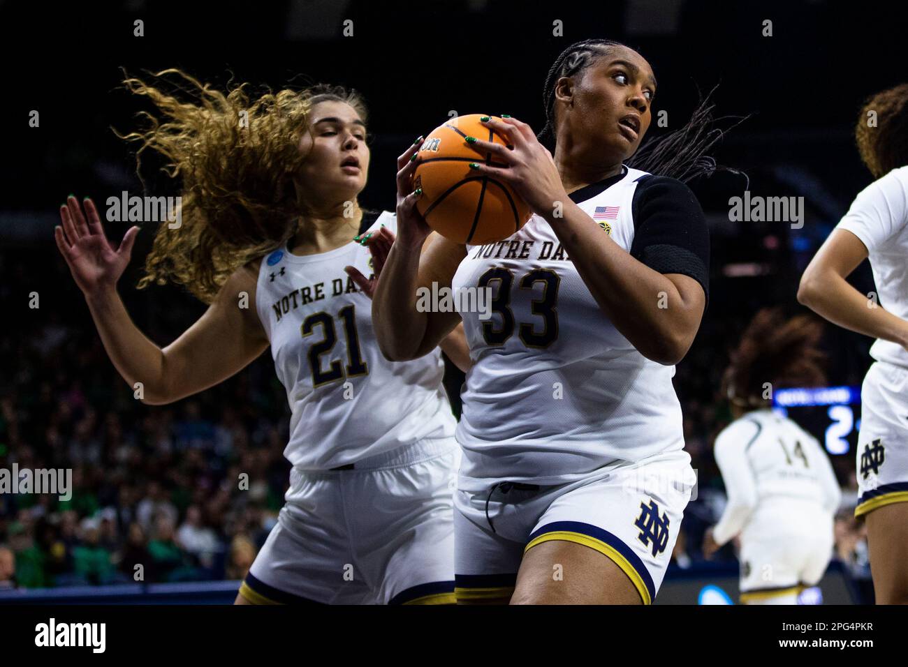Notre Dame's Lauren Ebo (33) and Maddy Westbeld (21) go for a rebound ...