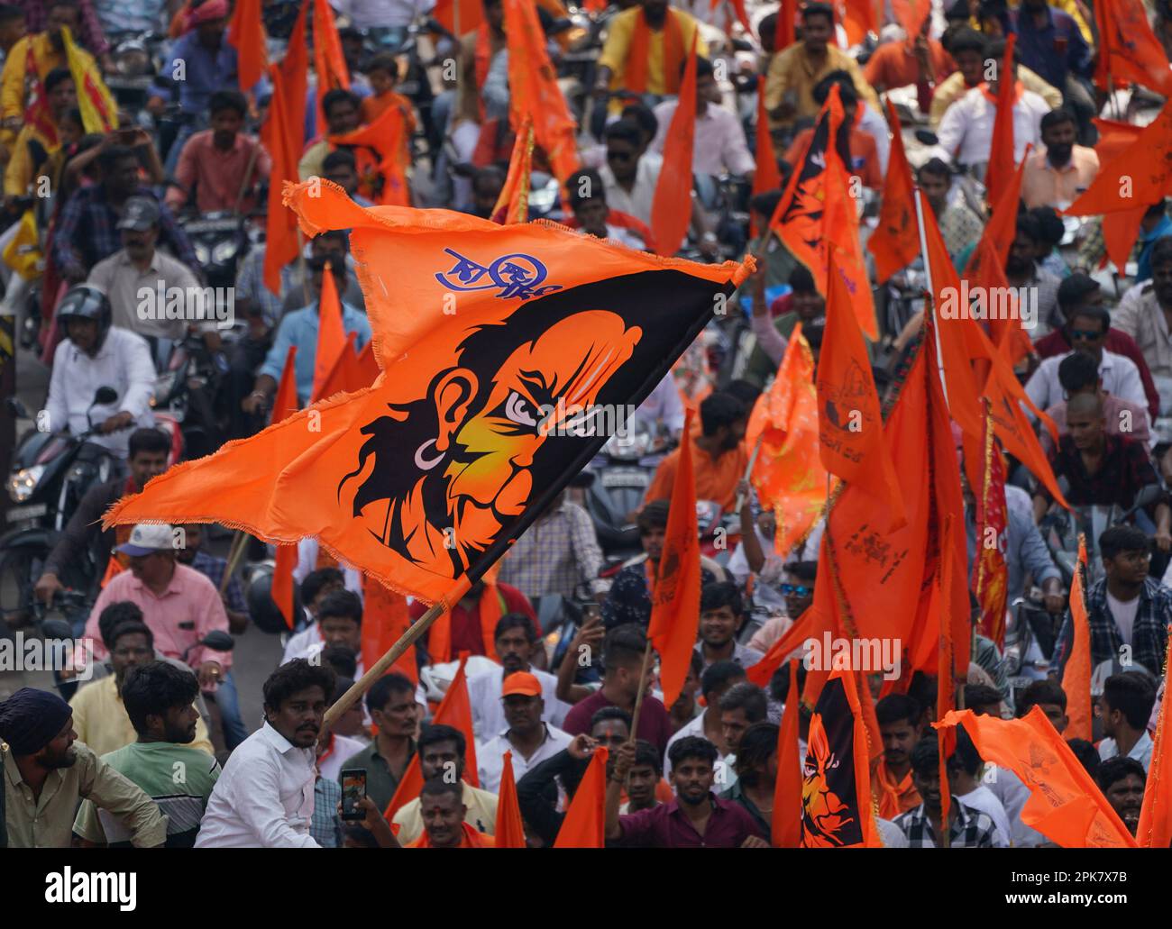 Devotees wave religious flags and participate in a procession to mark ...