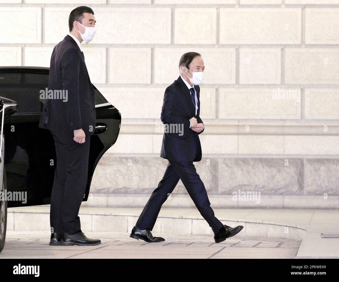 Kazuo Ueda (R), a new governor of the Bank of Japan (BO) arrives at its ...