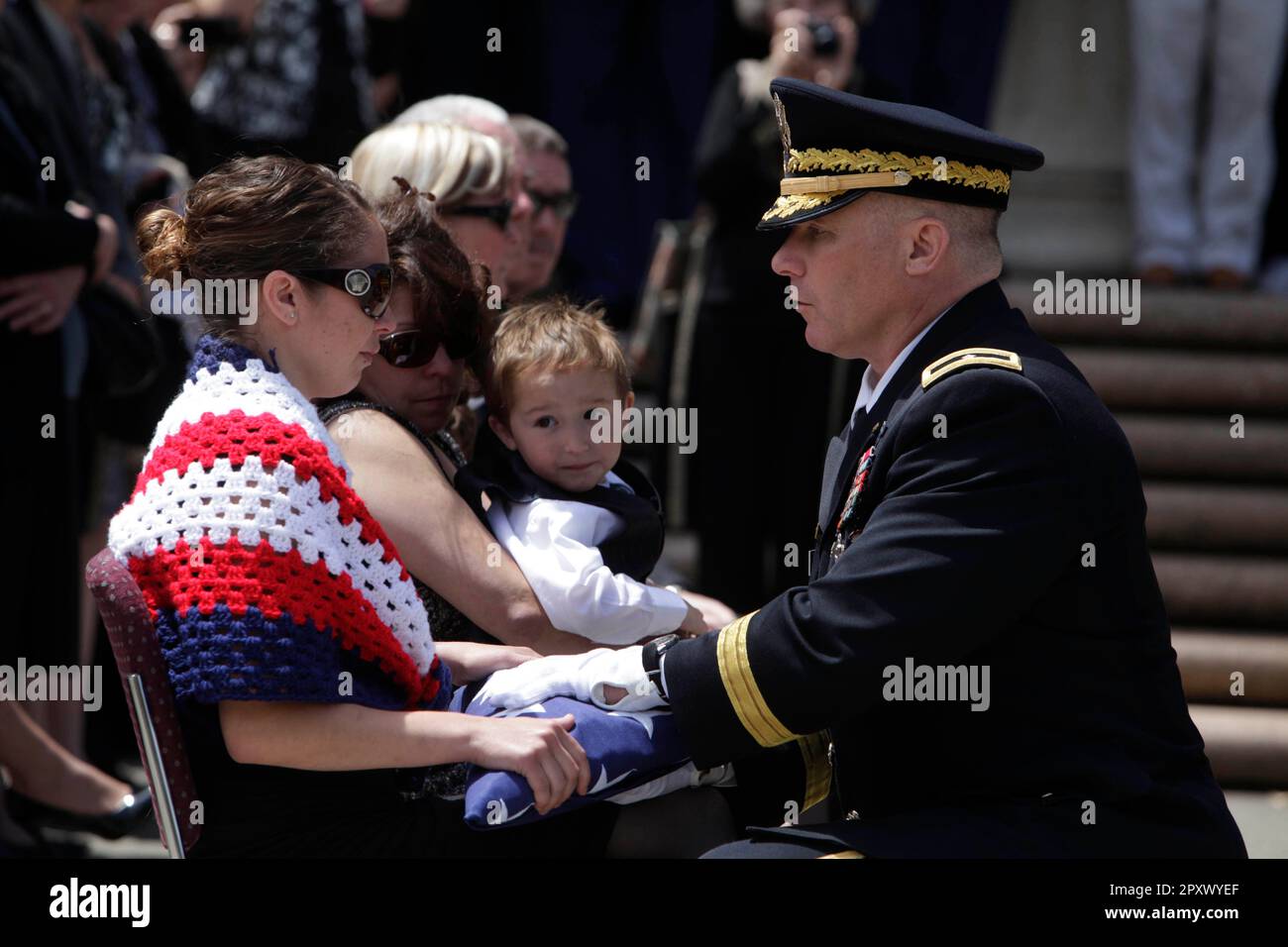 Brigadier General (P) Paul La Camera (right) presents a flag to Vanessa ...