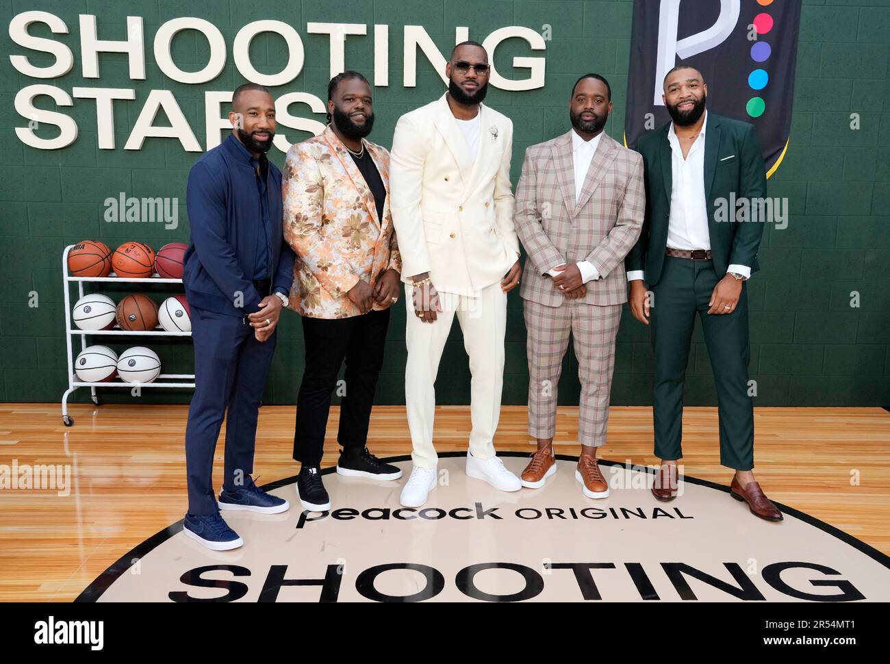 NBA basketball player LeBron James, center, poses with his high school ...