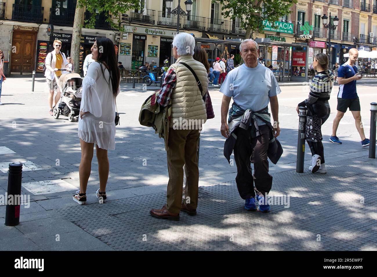 An elderly man walks through the city center on June 4, 2023, in Madrid ...