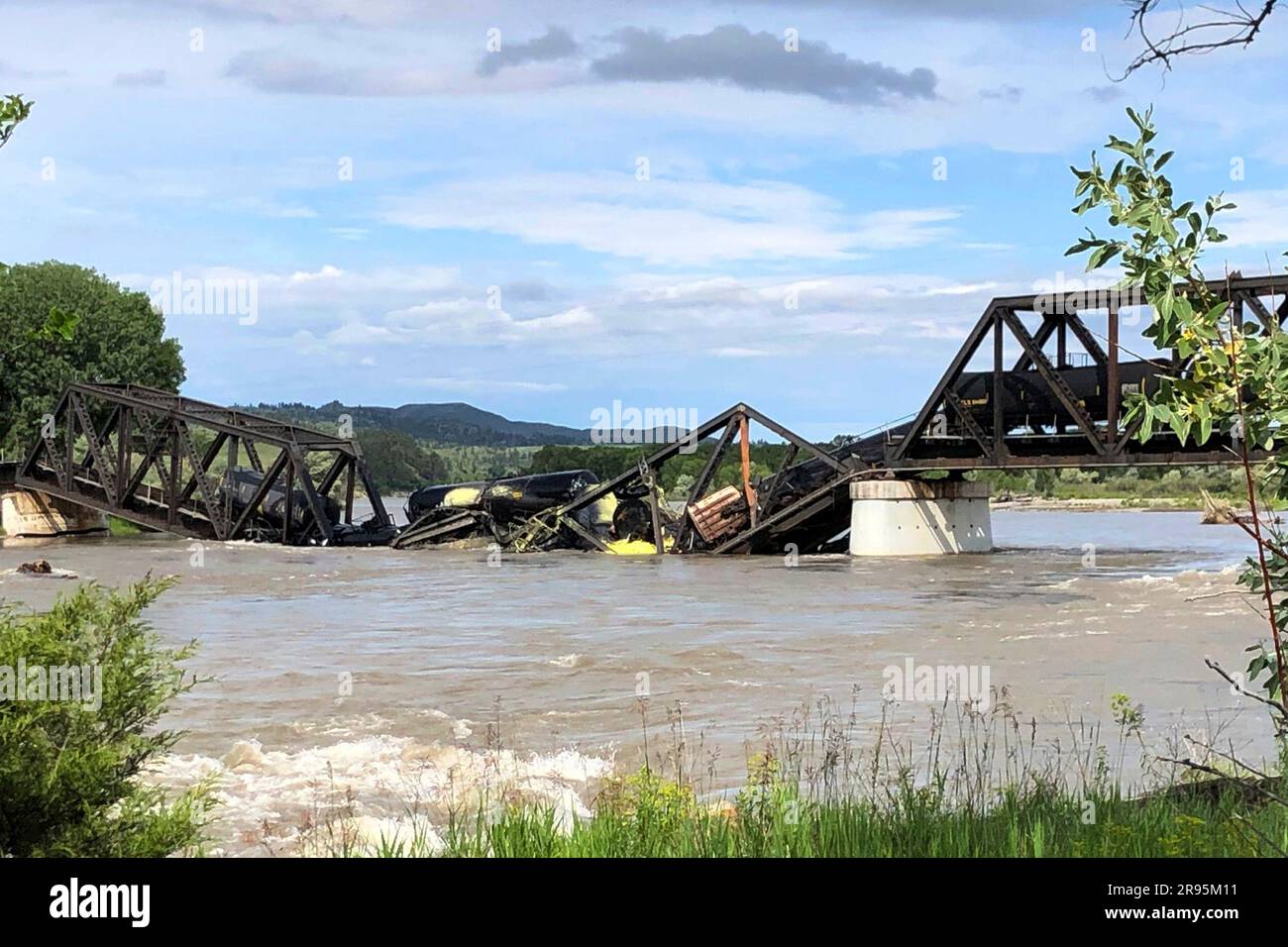 Several train cars are immersed in the Yellowstone River after a bridge ...