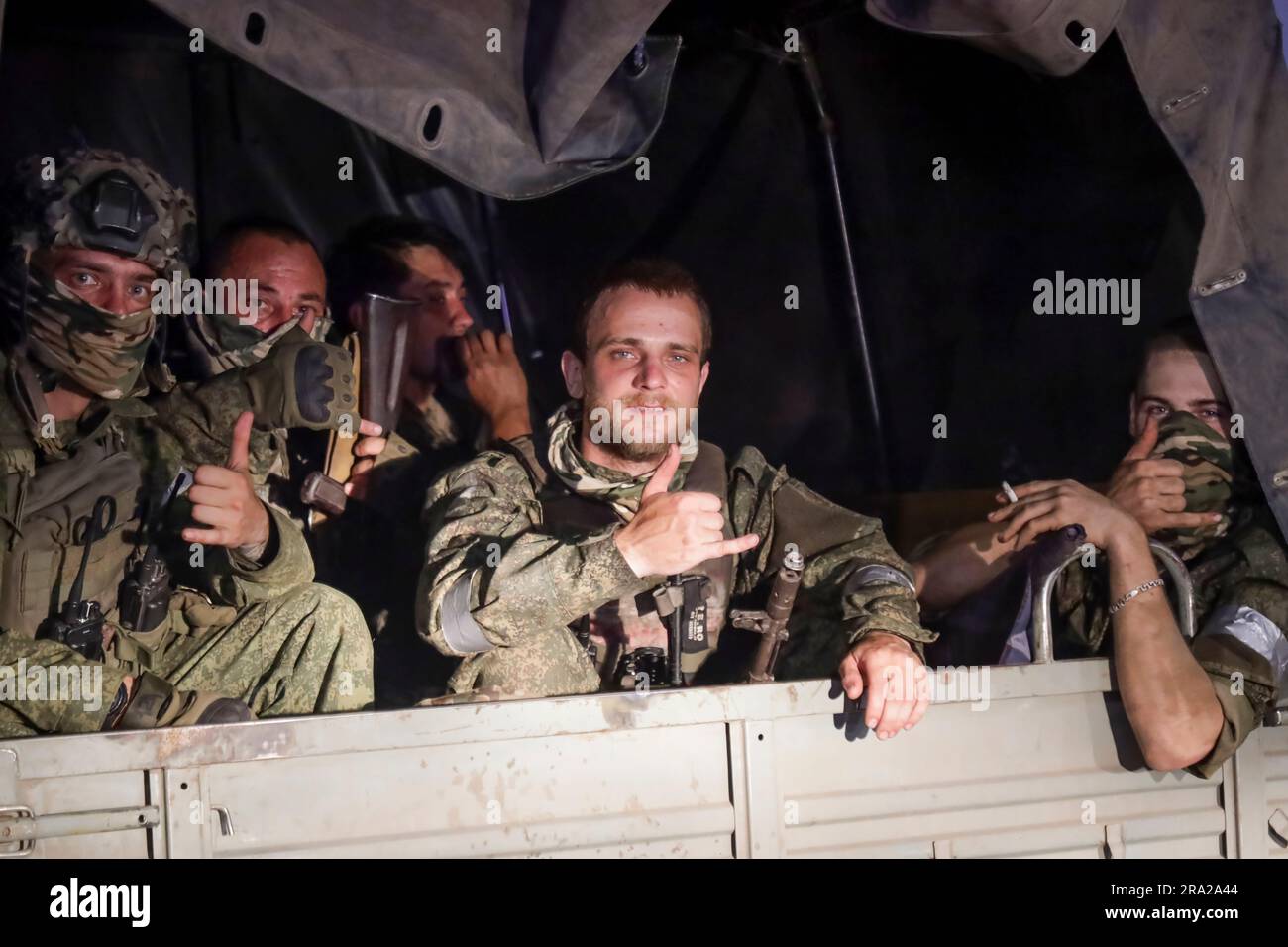 FILE - Members of the Wagner Group military company sit in their ...