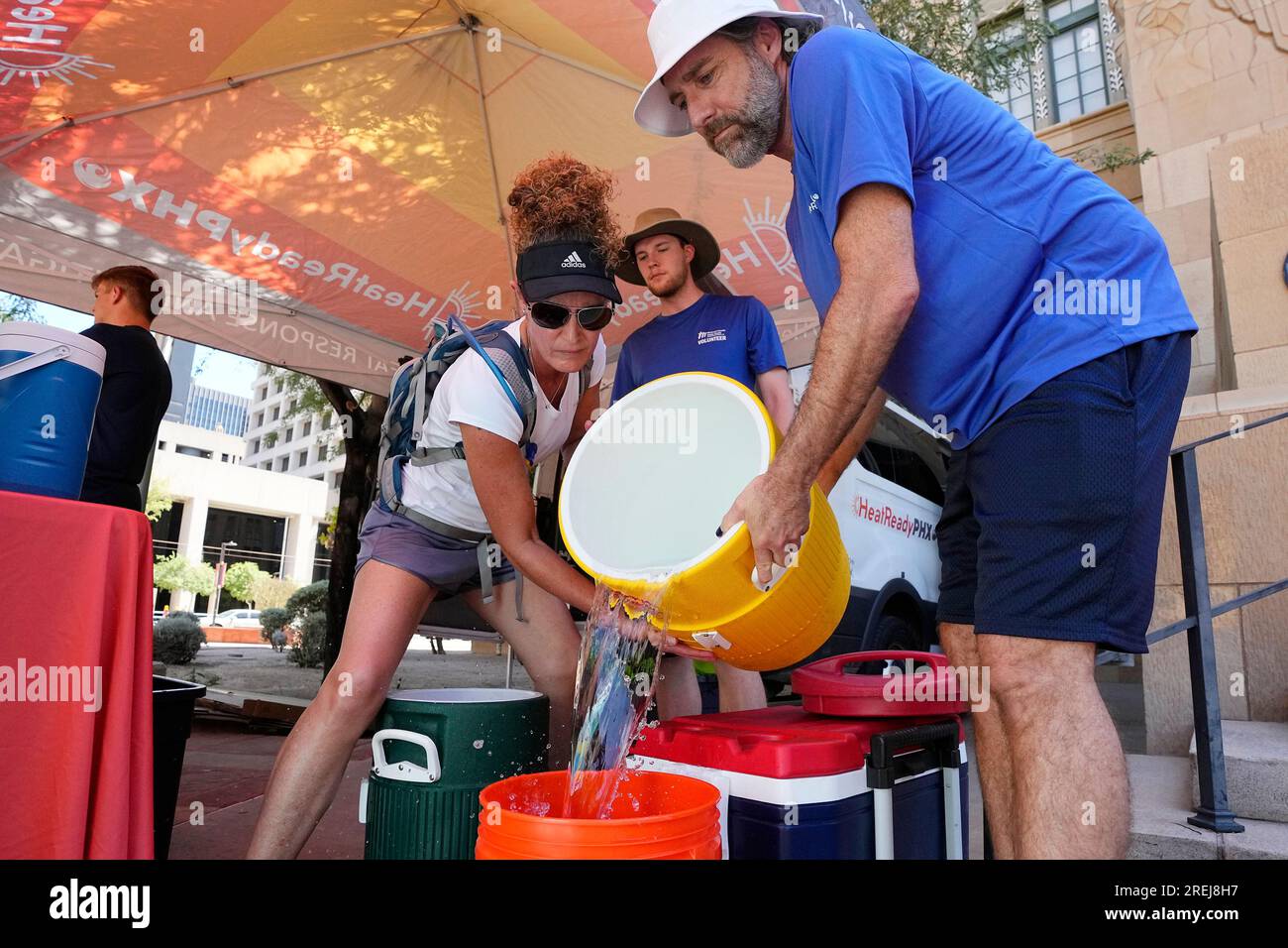 FILE - The City of Phoenix Heat Response Program team volunteers ...