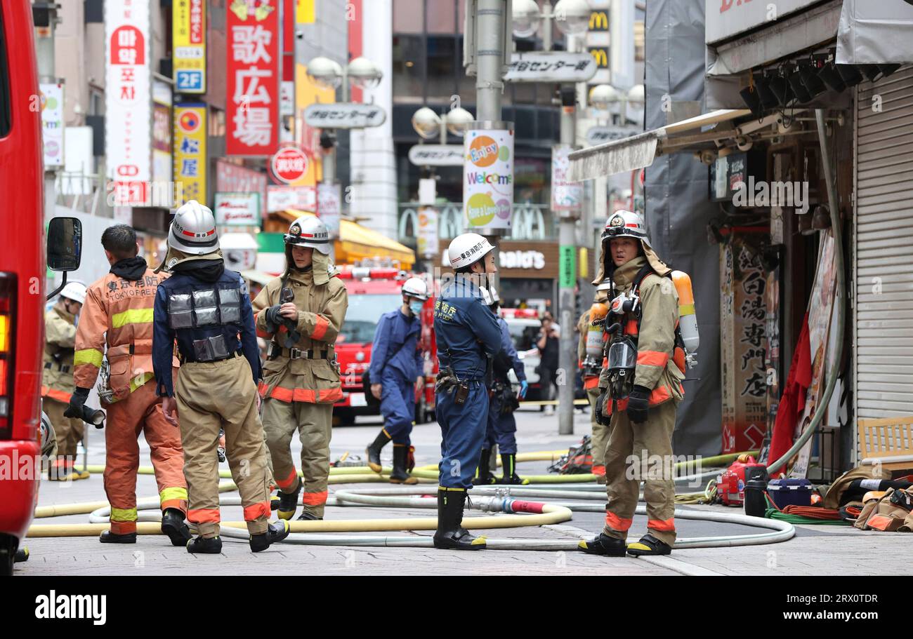 Firefighters inspect the area of fire at Center Gai near Shibuya ...