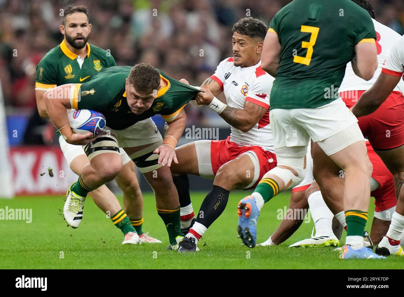 South Africa's Jasper Wiese, left, is held by the shirt by Tonga's ...