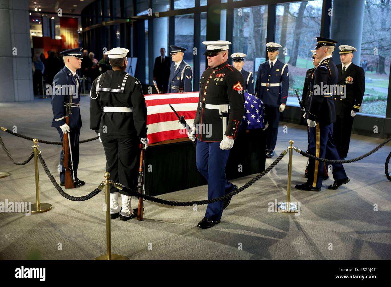 Members of the joint services military honor guard conduct a changing of the guard next to the ...
