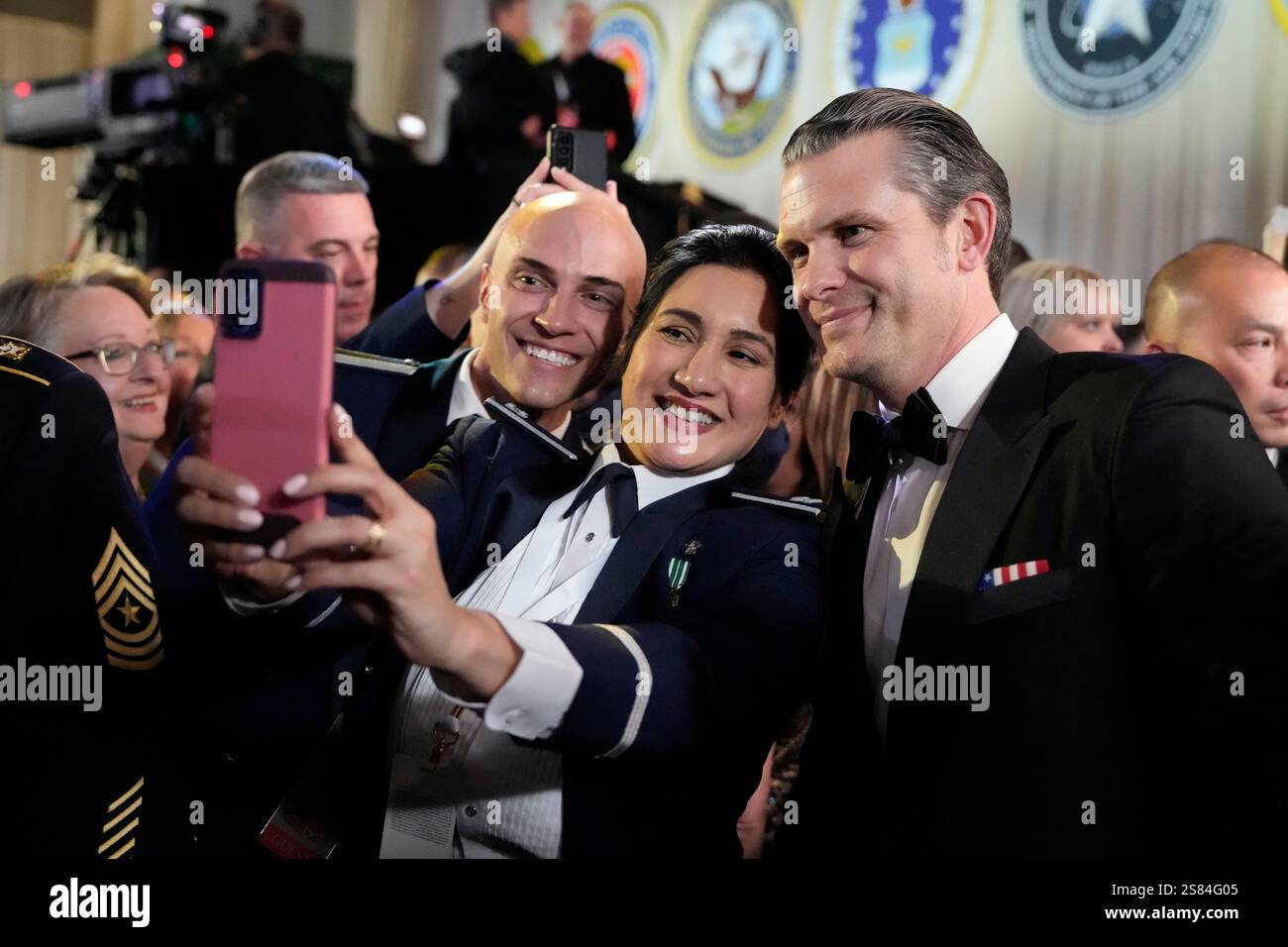 Defense Secretary nominee Pete Hegseth, right, takes a photo with ...