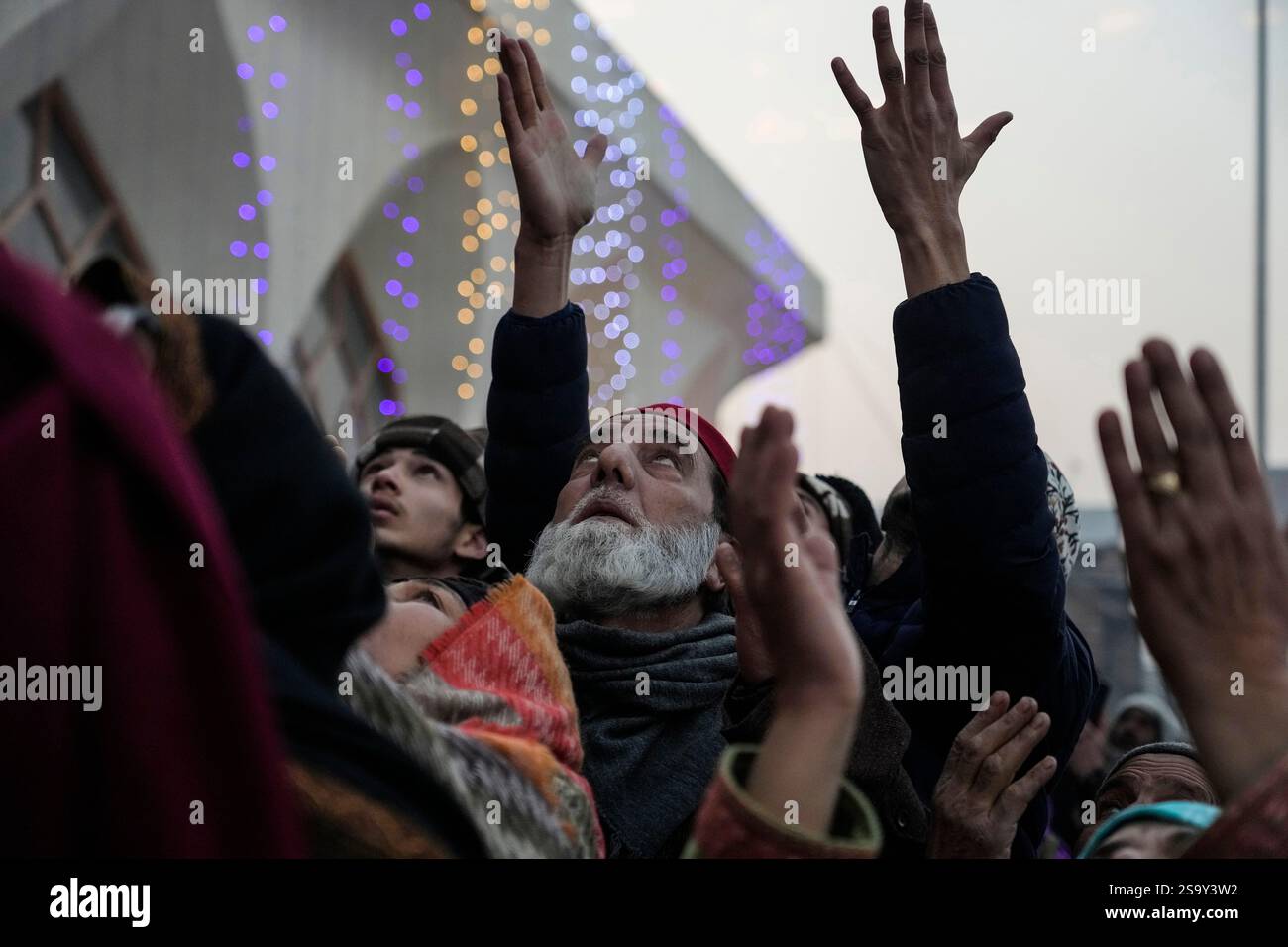 Kashmiri Muslim devotees pray as a head priest displays a relic ...