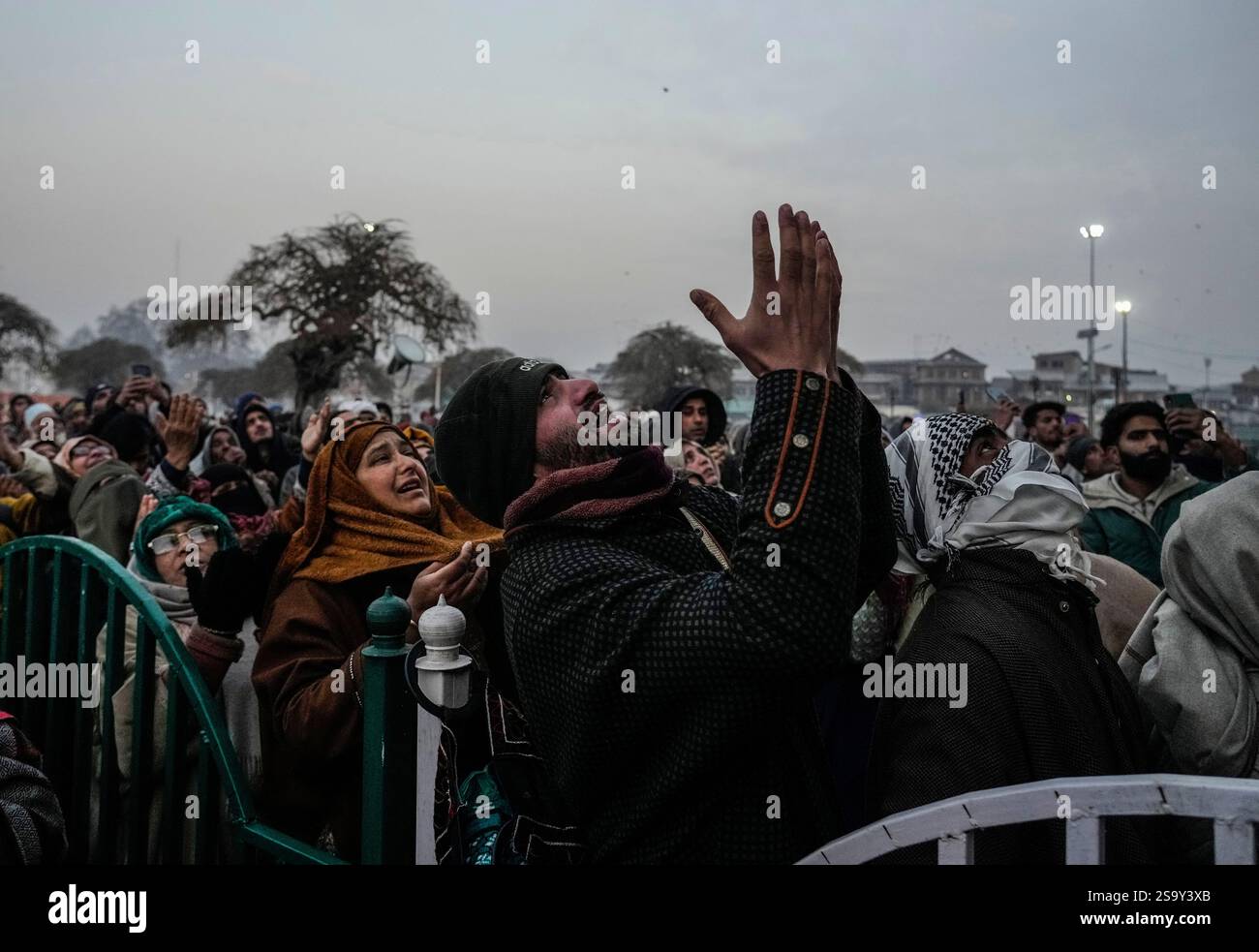 Kashmiri Muslim devotees pray as a head priest displays a relic ...