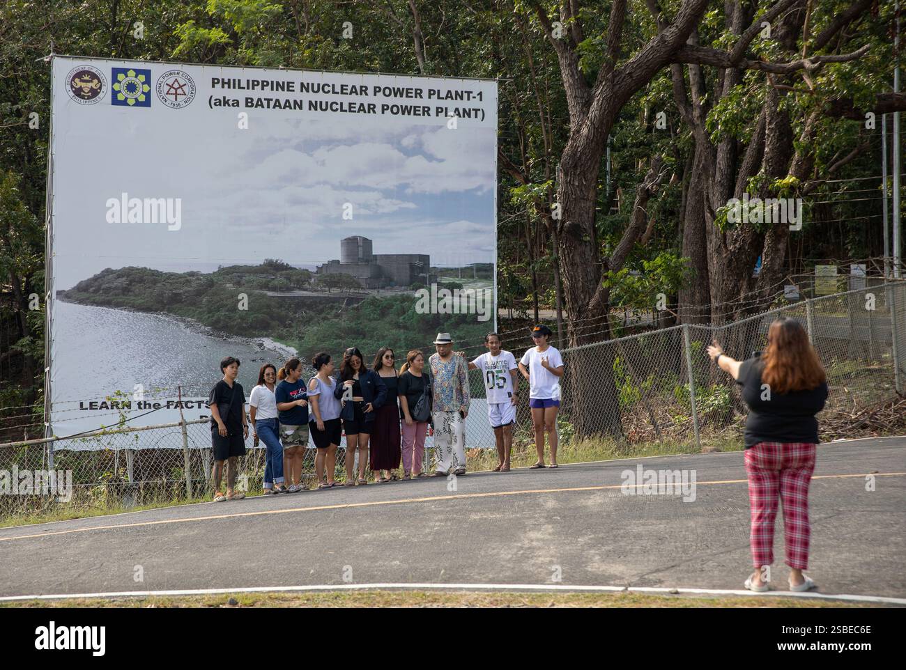 Filipino tourists pose for a photo in front of the billboard ...