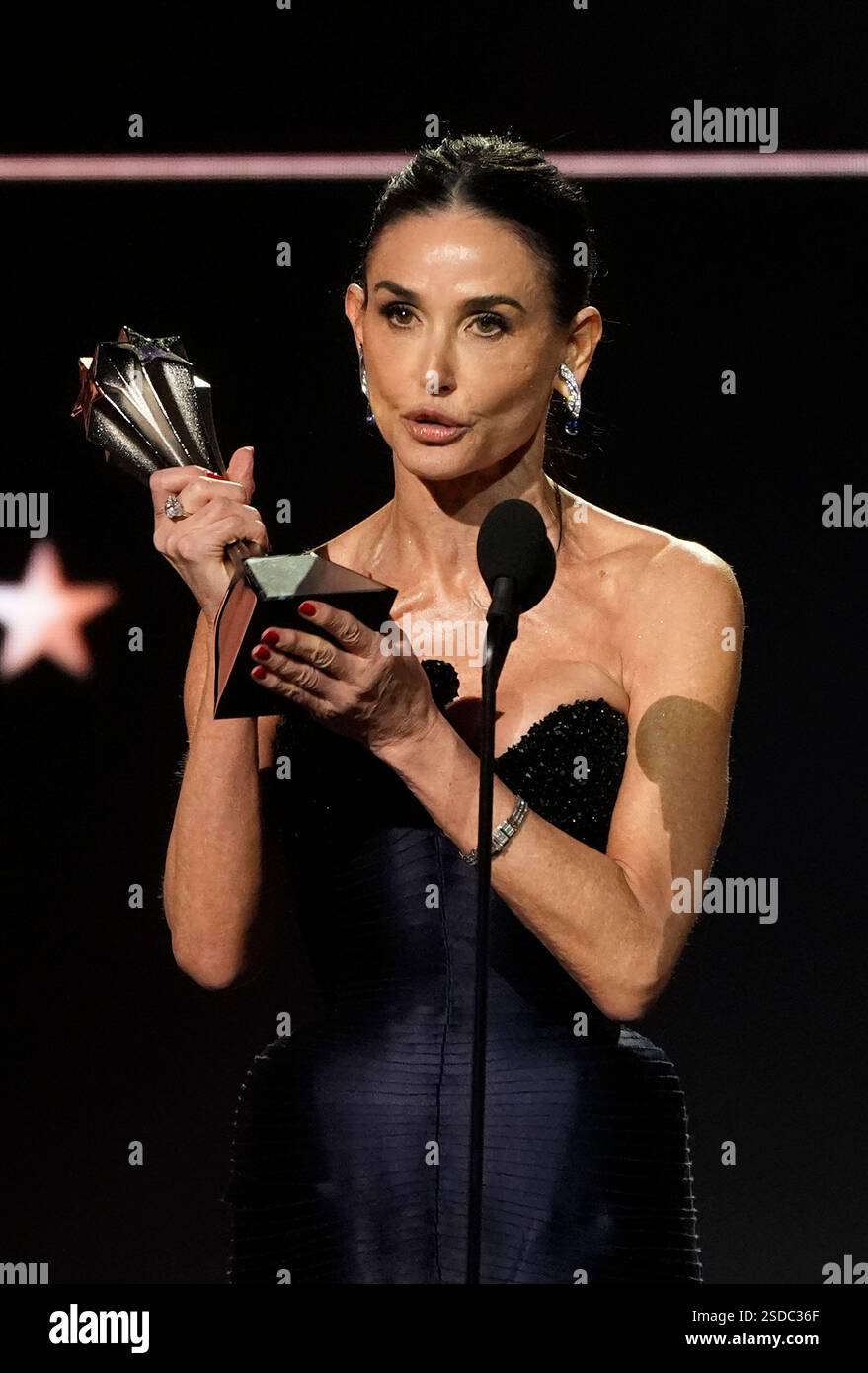 Demi Moore accepts the best actress award for "The Substance" during ...
