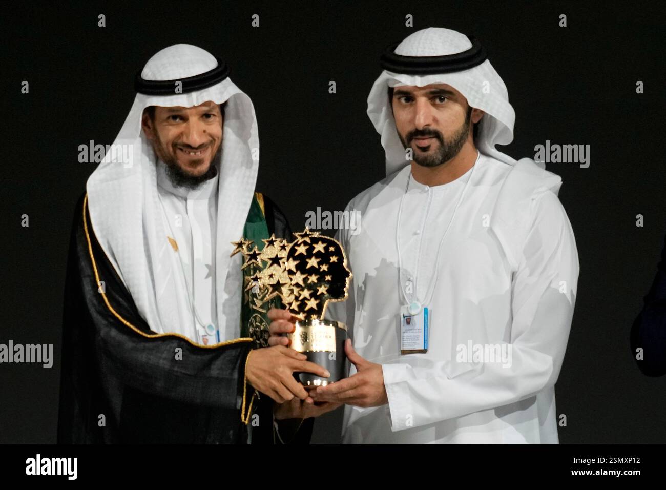 Saudi Arabian teacher Mansour bin Abdullah Al-Mansour, left, receives the Global Teacher Prize ...