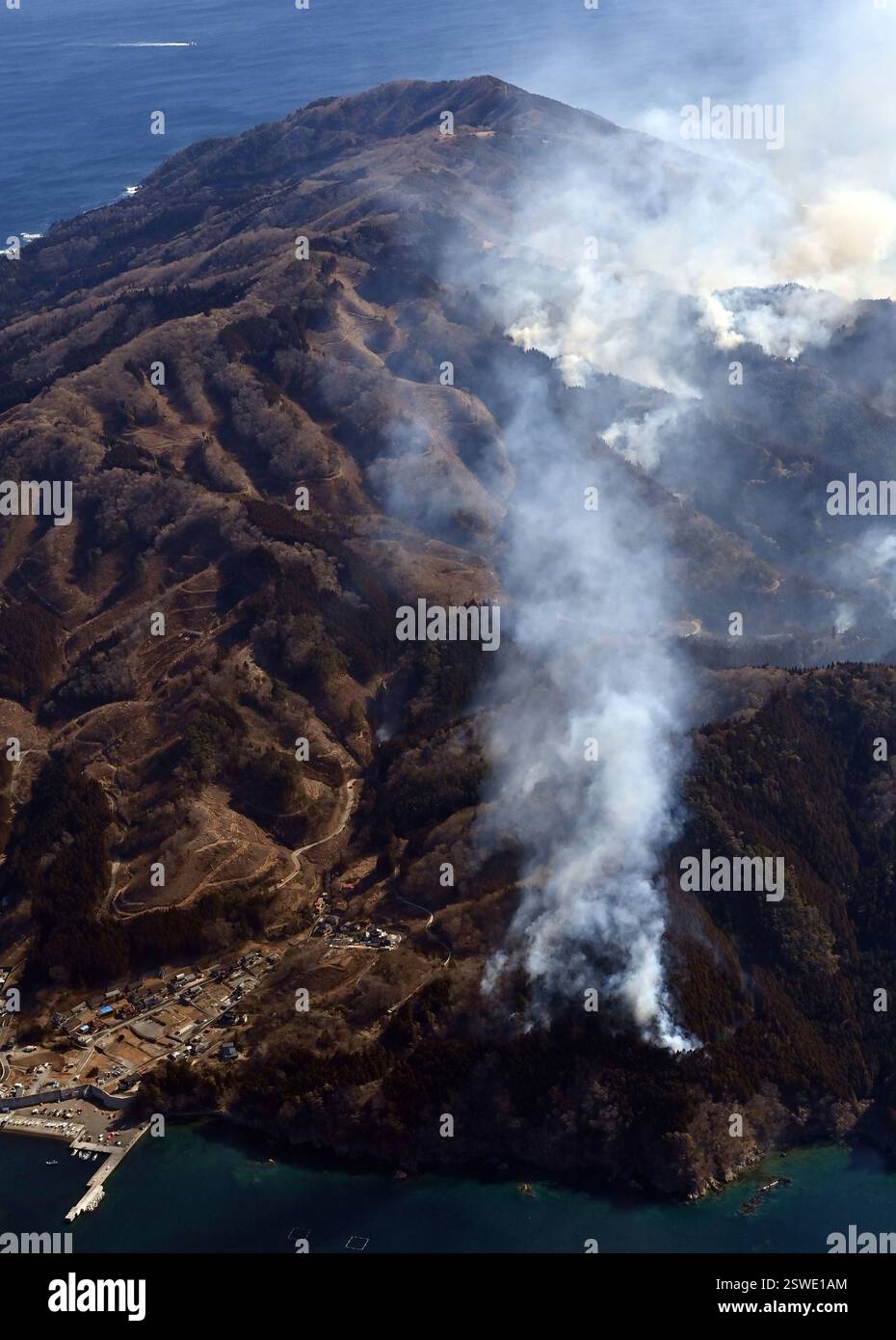 An aerial photo shows a forest fire, continues to spread in Ofunato ...
