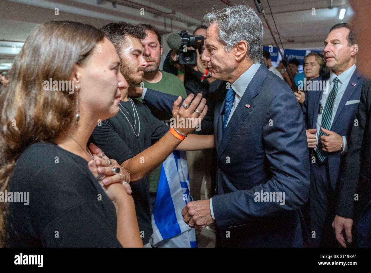 U.S. Secretary of State Antony Blinken is embraced by Lior Gelbaum ...