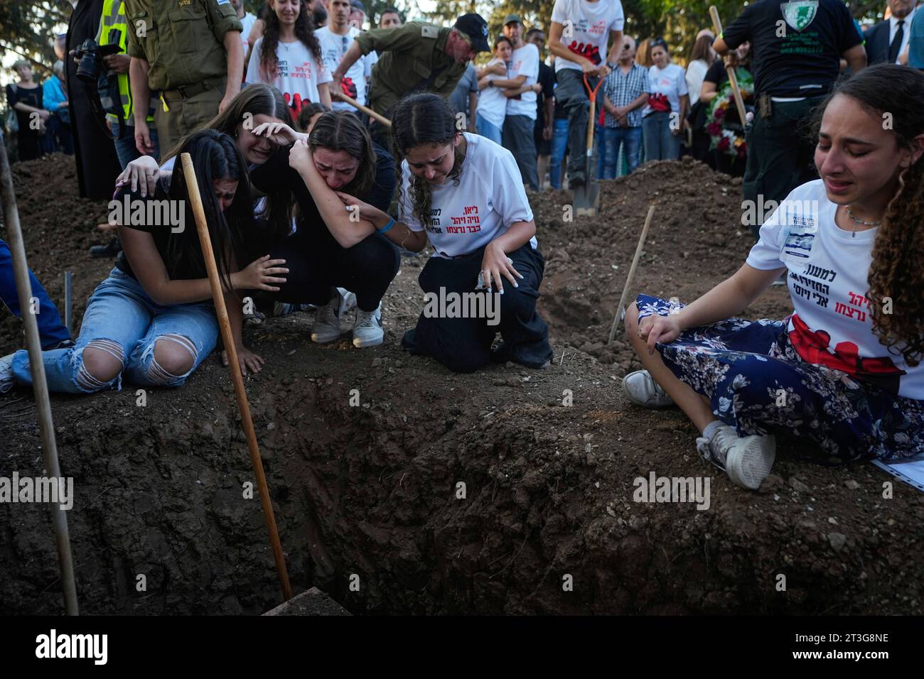 Mourners gather around the graves of British-Israelis Lianne Sharabi ...