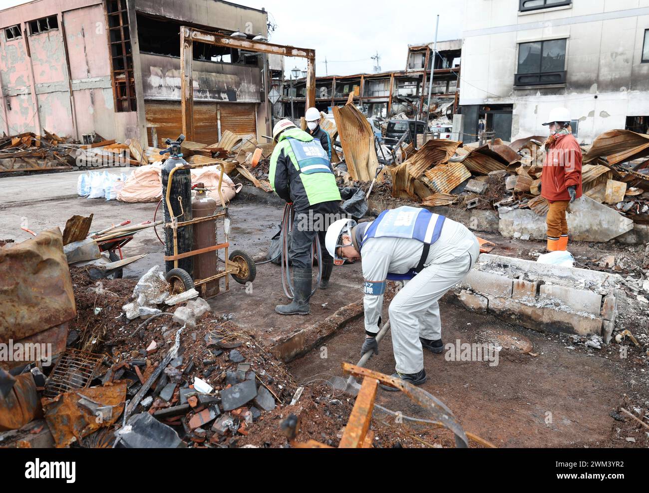 Volunteers remove debris at a disaster-stricken area in Wajima City ...
