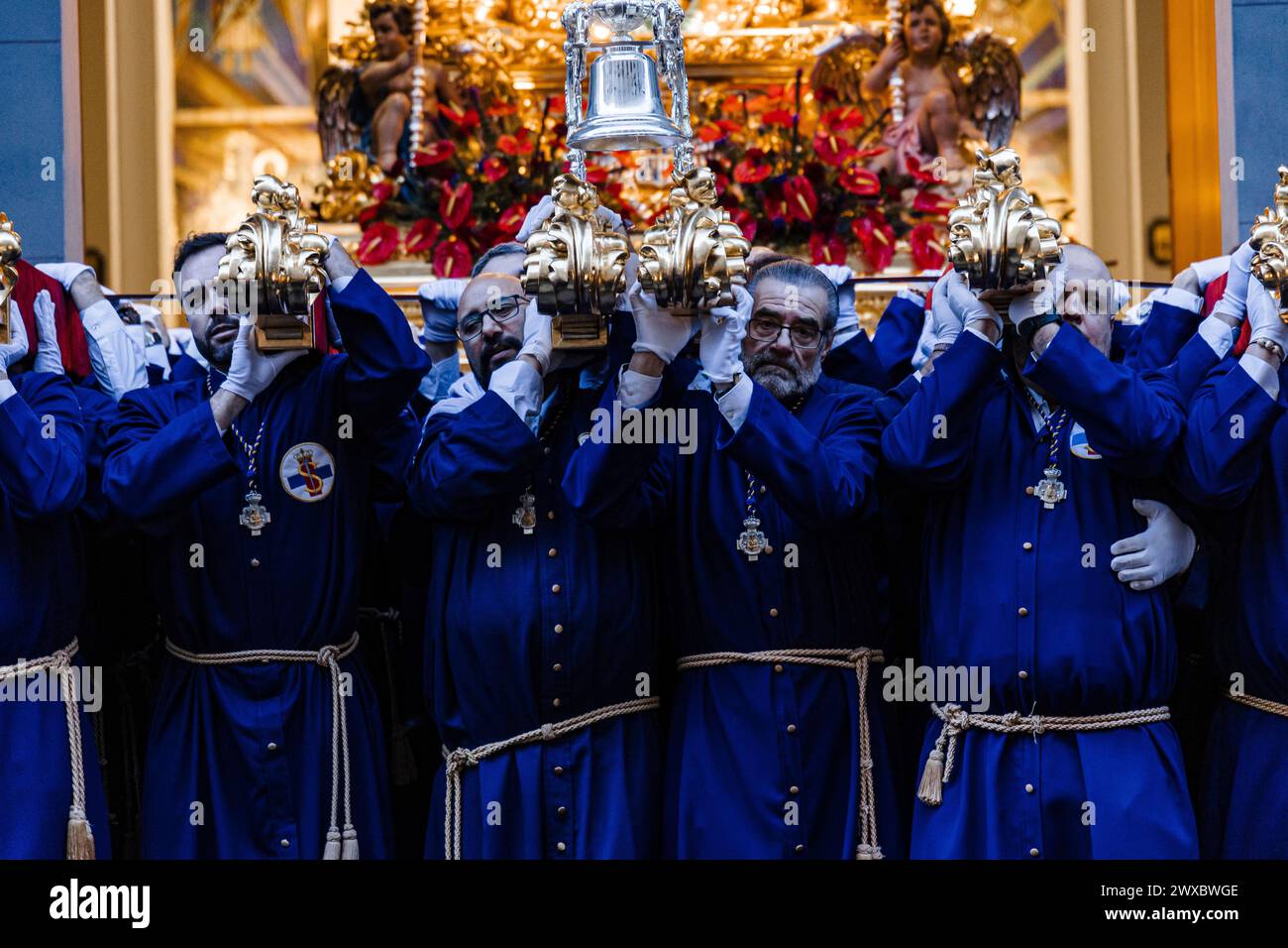 Several people carry the throne during the procession of the Christ of ...