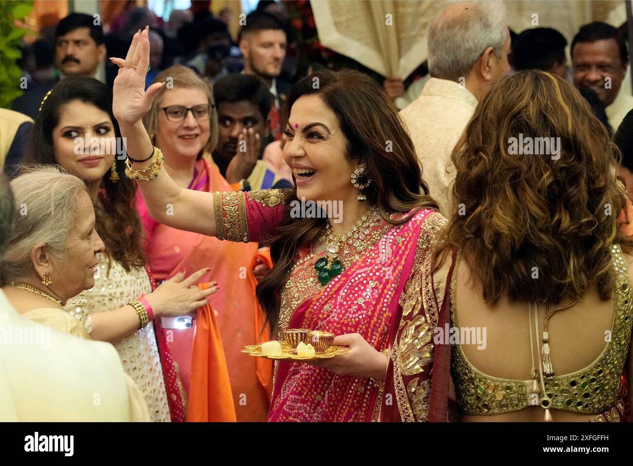 Nita Ambani, center, wife of Reliance Industries Chairman Mukesh Ambani, greet guests during a ...