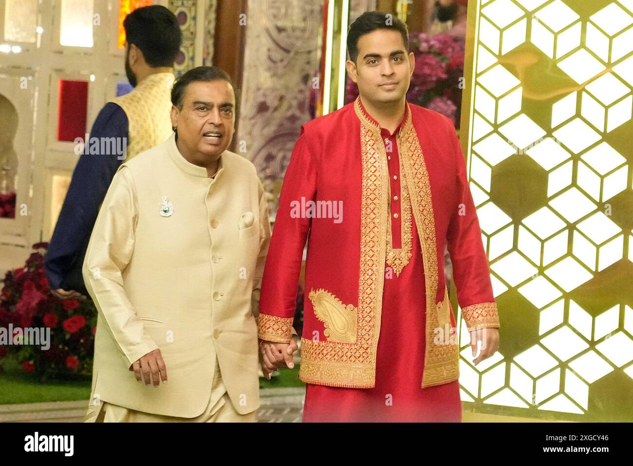 Chairman of Reliance Industries Limited Mukesh Ambani, left, and his son Akash Ambani pose ...