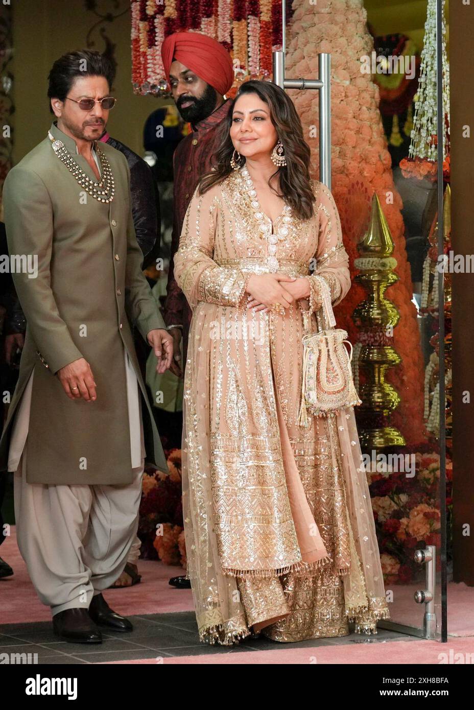 Bollywood actor Shah Rukh Khan and his wife Gauri arrive at the wedding ...
