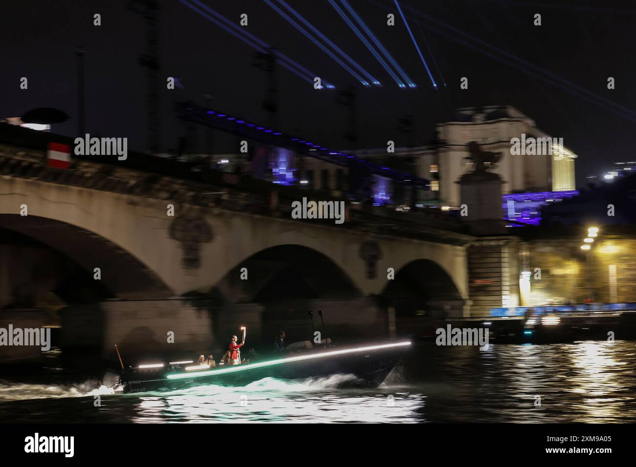 Spain's tennis player Rafael Nadal holds the Olympic flame during a ...
