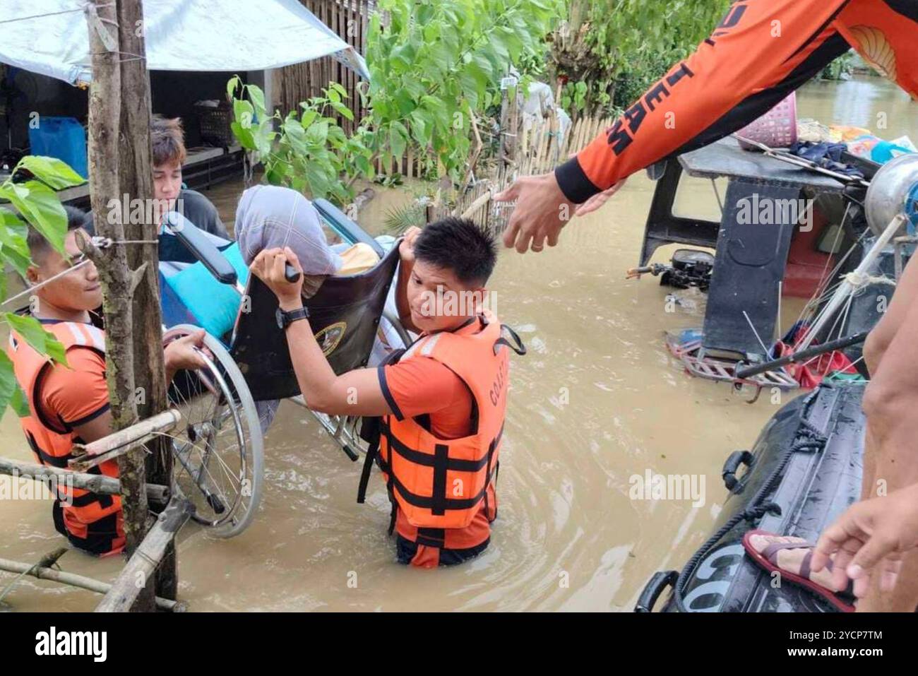 In this handout photo provided by the Philippine Coast Guard, rescuers carry a resident trapped ...