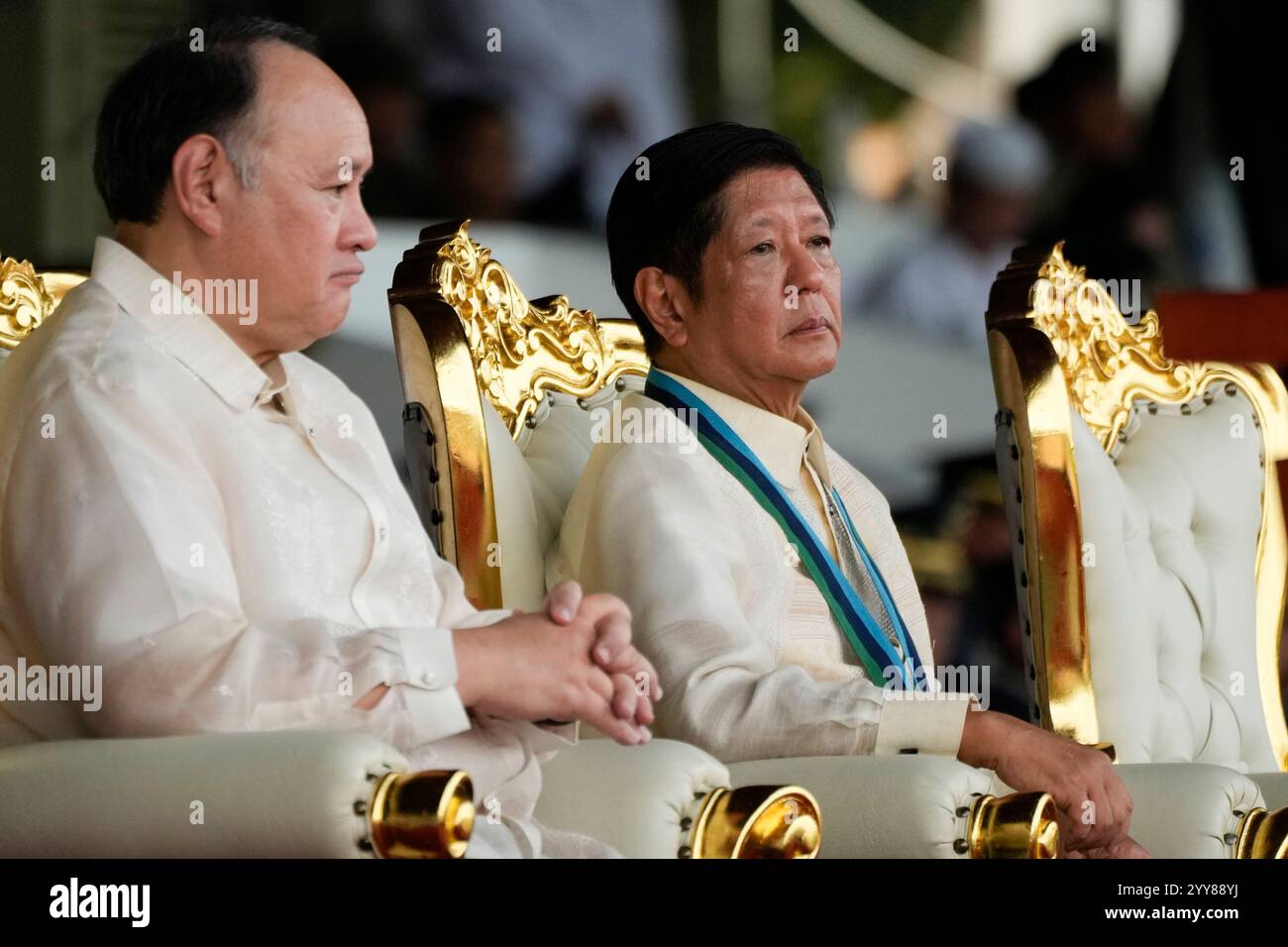Philippine President Ferdinand Marcos Jr., right, sits beside ...