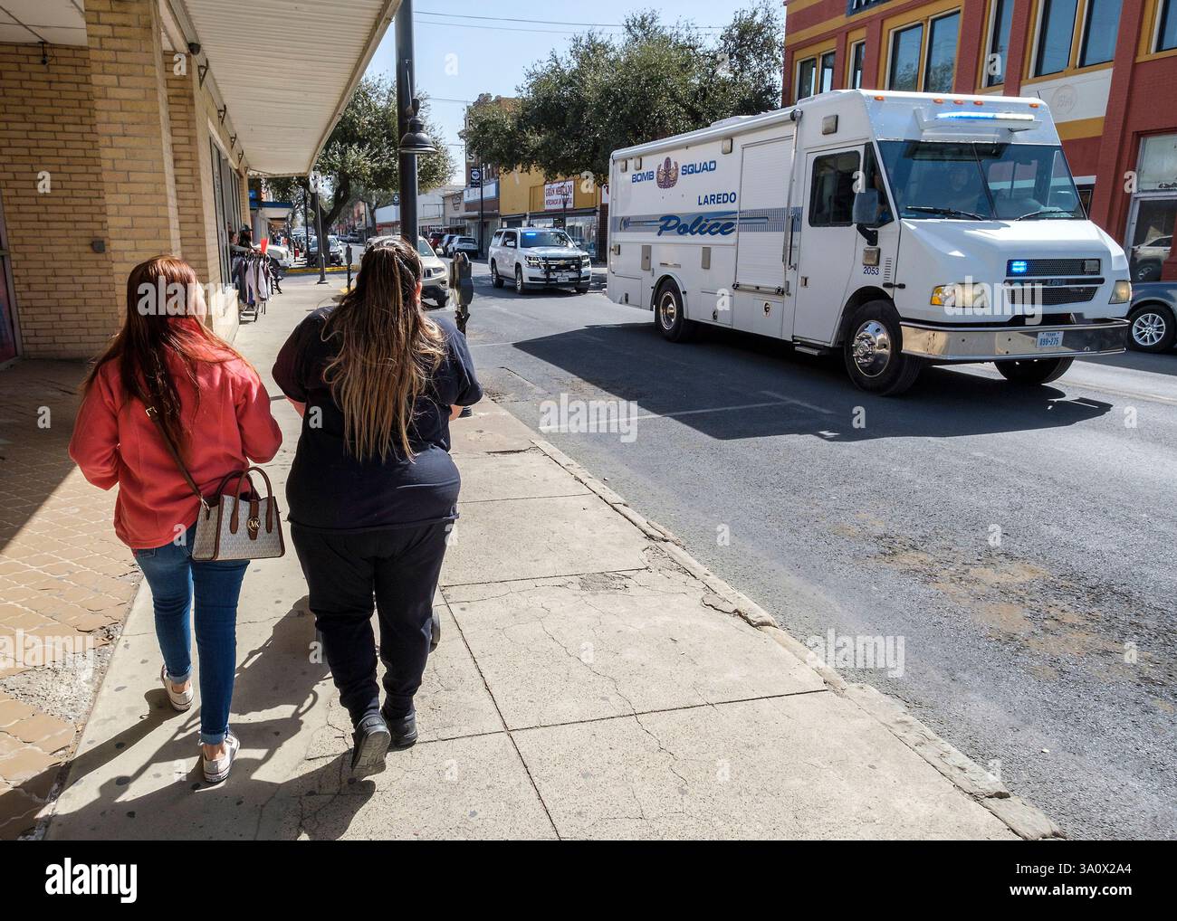 Bianca, left, and Claudia, right, (last names not shared) walk along Main Street in downtown ...
