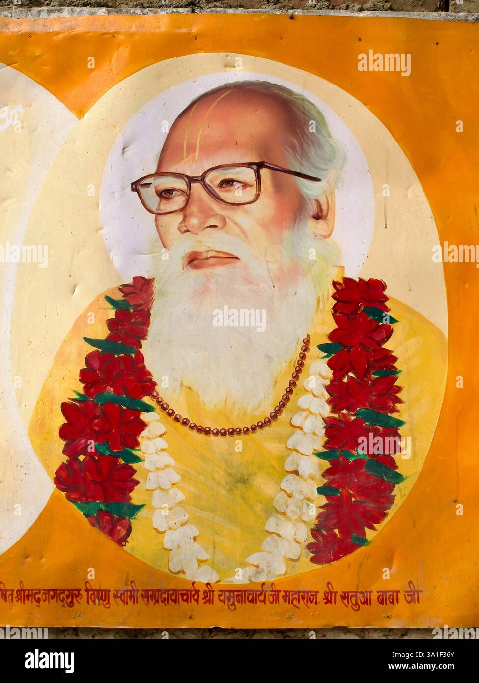 Murale raffigurante Shri Sadhu Baba Ji, un venerato santo indù, accanto ...