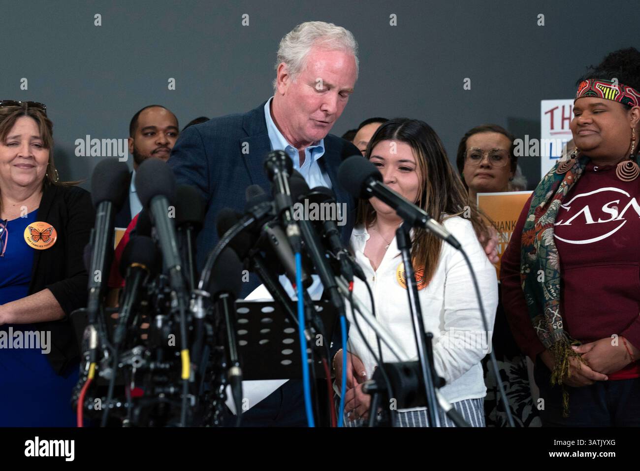 Sen. Chris Van Hollen, D-Md., center, hugs Jennifer Vasquez Sura, right ...