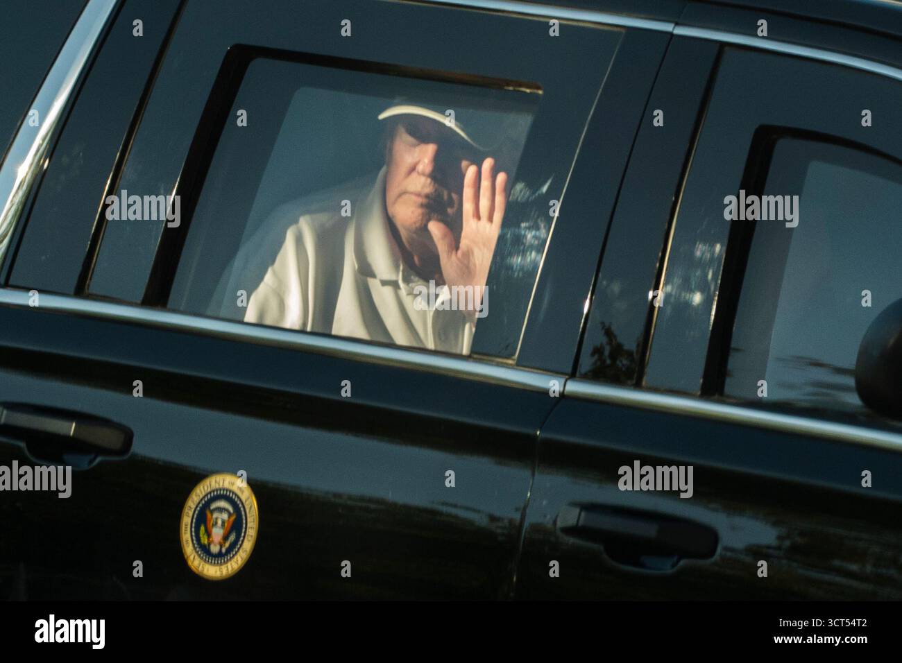 President Donald Trump waves as he leaves Trump National Golf Club in ...