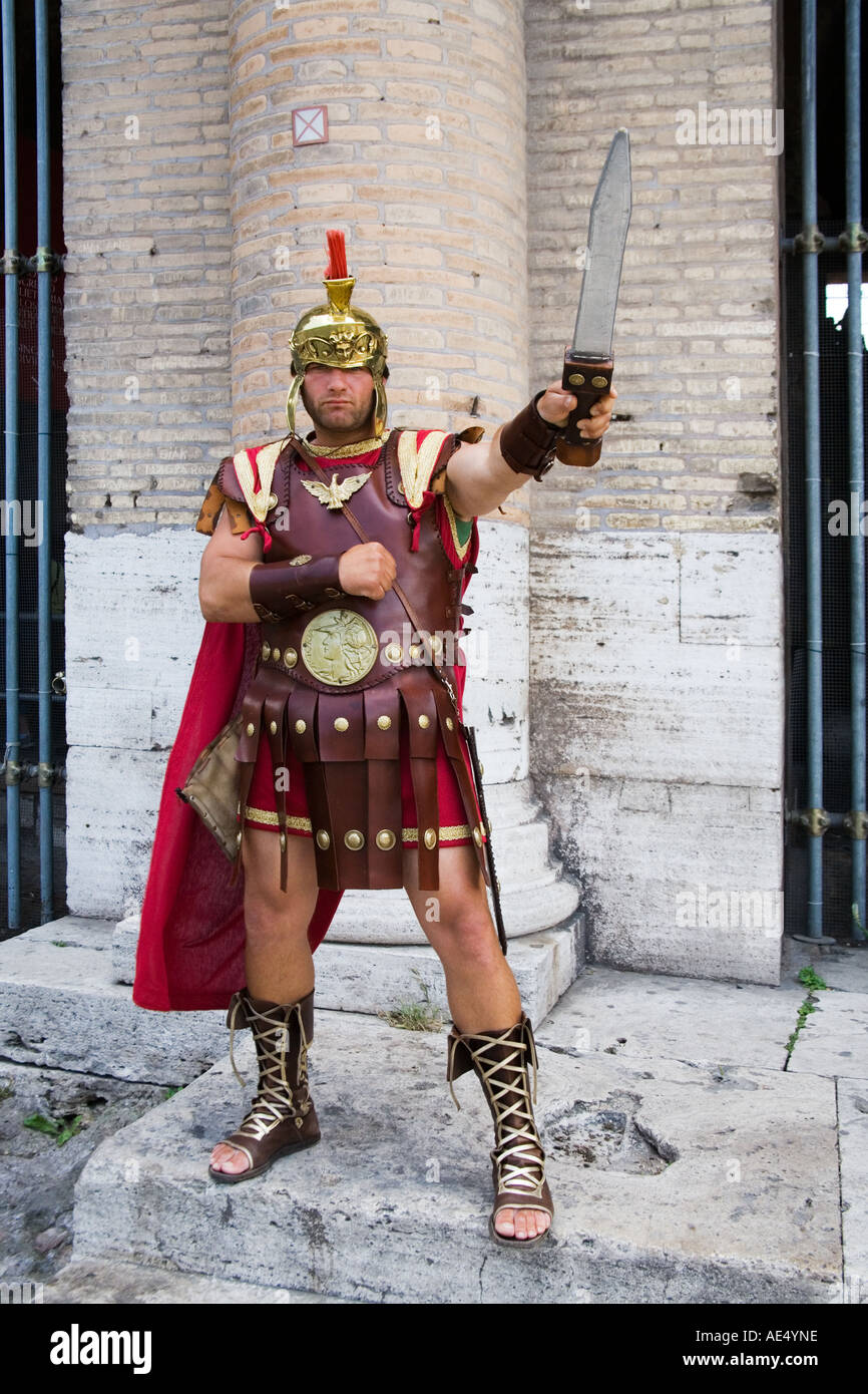 Uomo vestito come un gladiatore romano sorge al di fuori del Colosseo a ...