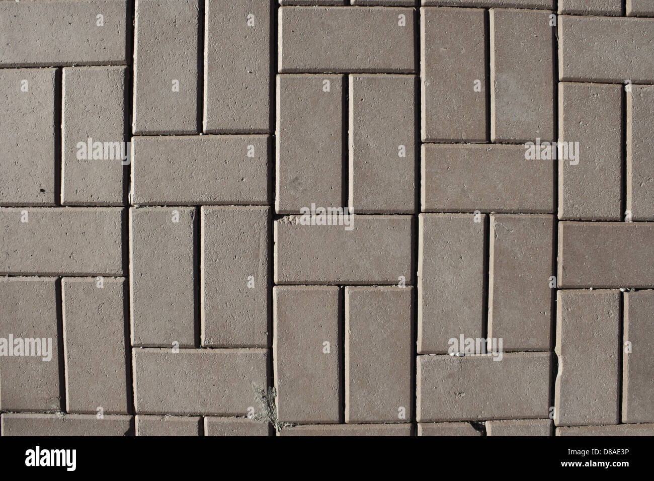 In mattoni grigi lastricatori marciapiede texture Foto stock - Alamy