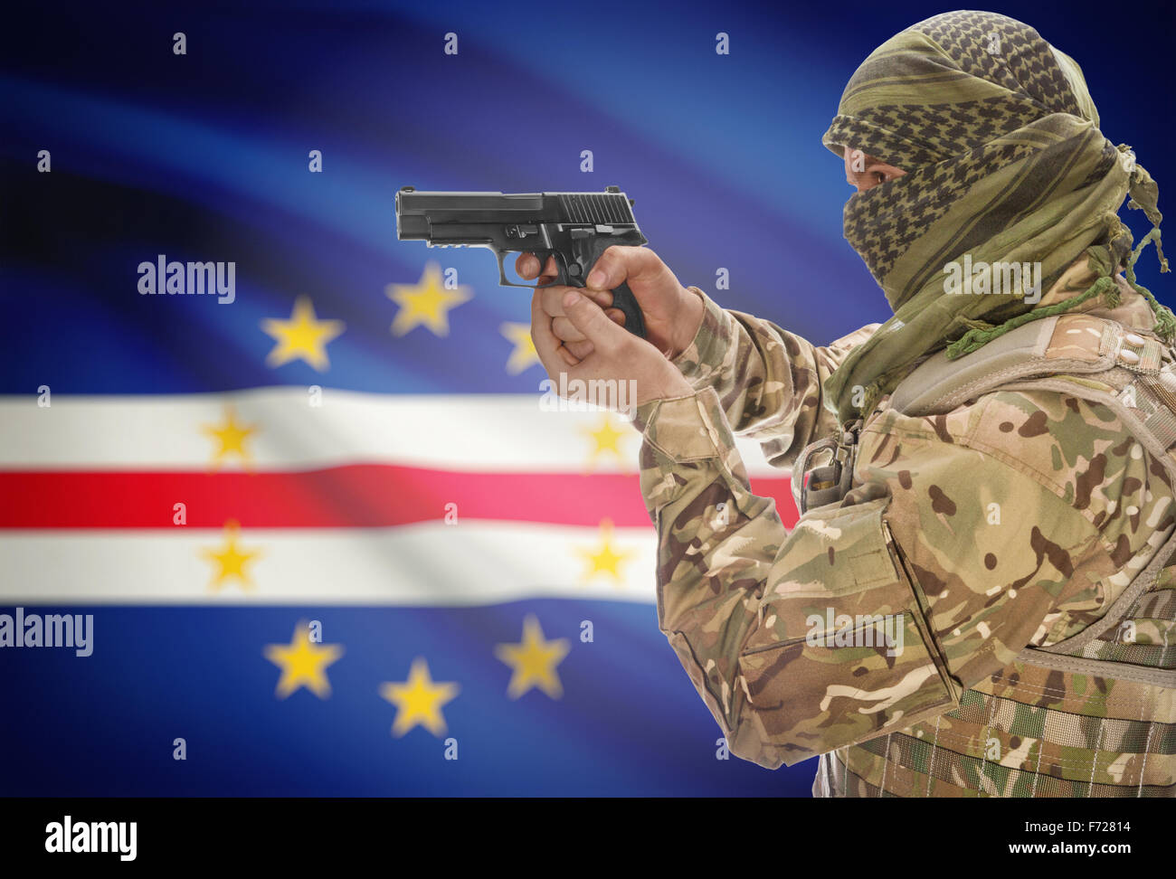 In maschio keffiyeh musulmano con la pistola in mano e bandiera ...
